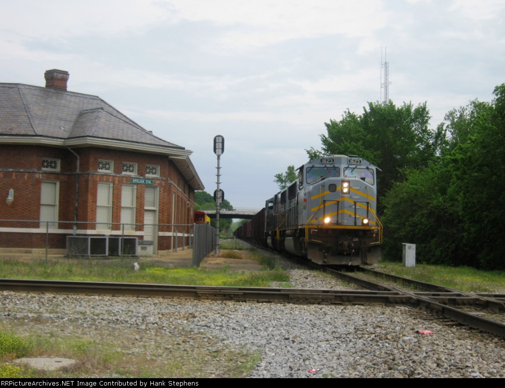 TFM 1623 waits beside the restored Opelika depot to cross the CSX AWP-WofA main.